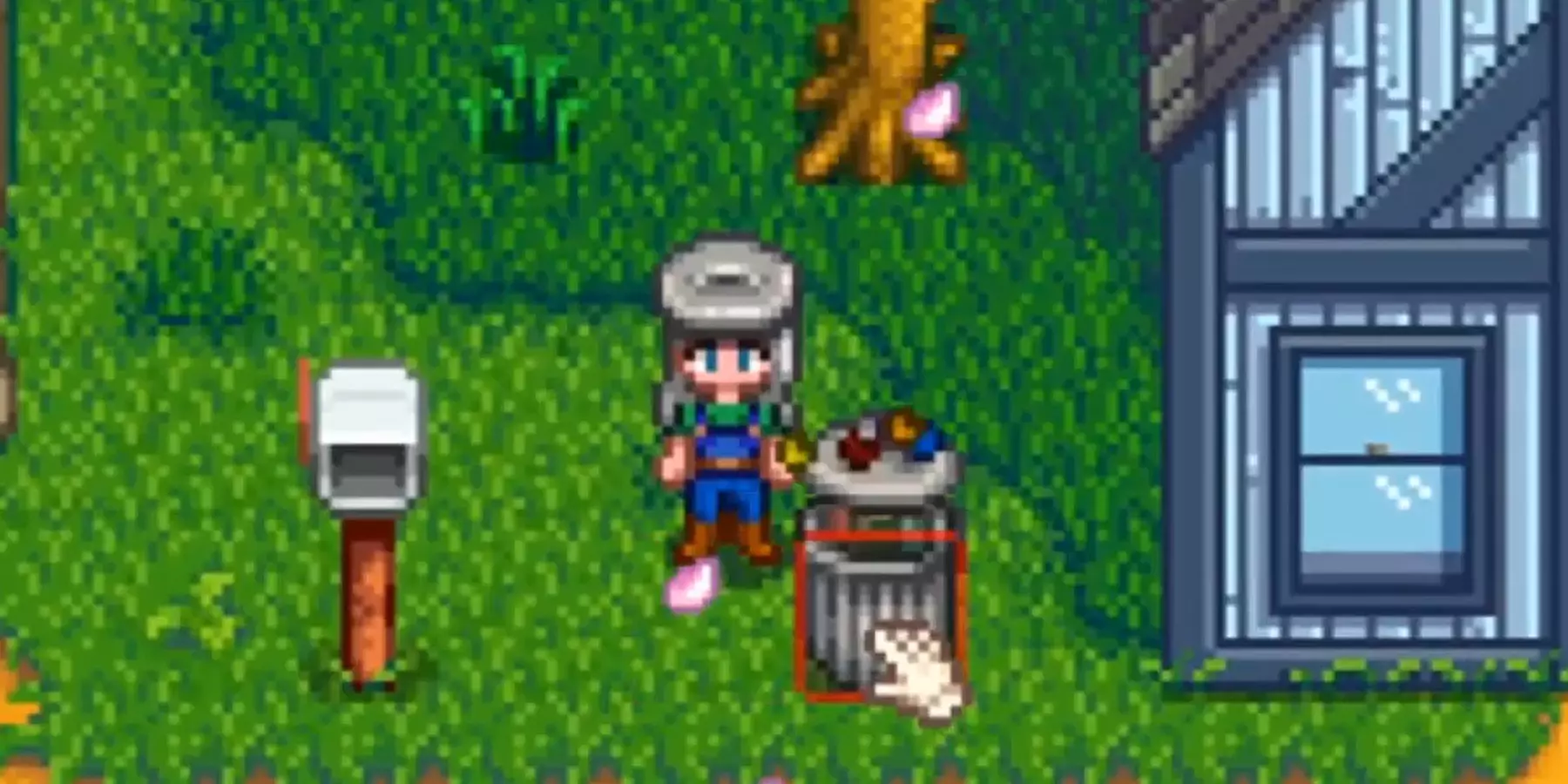 Personagem de Stardew Valley ao lado de uma lata de lixo usando chapéu de lixo