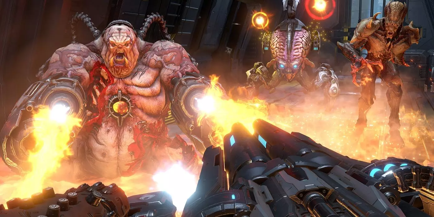 来自 Doom Eternal 的屏幕截图显示了一把枪向 Mancubus 生物开火。