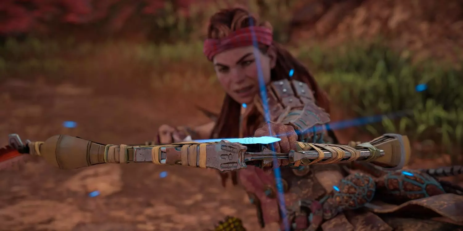 si aloy na dumudulas sa lupa habang kumakatok ng arrow na kumikinang na asul