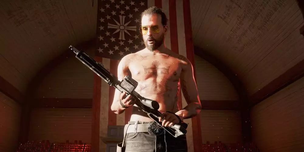 Far-Cry-5-Joseph-Seed-In-Front-of-American-Flag-Holding-Gun